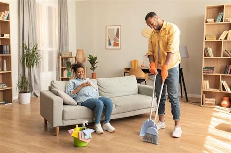 Premium Photo Pregnancy And Household Help Black Husband Cleaning
