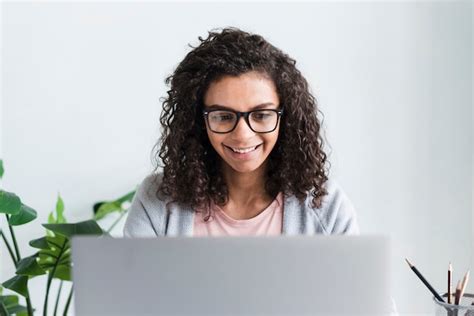 Free Photo Ethnic Female Employee With Glasses Working At Laptop
