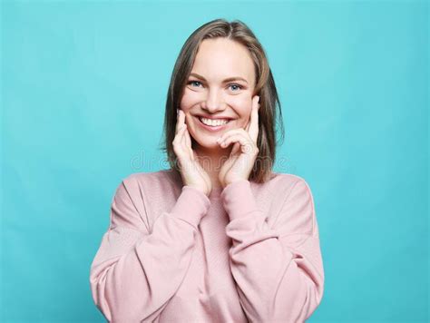 A Cheerful Funny Young Woman Grimaces At The Camera Presses Her