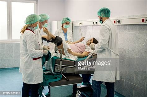 Obstetricians Assisting In The Hospital Woman In Labor Pushes To Give