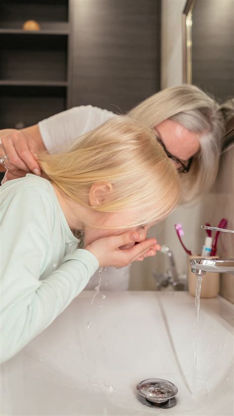Grandmother Teaching Her Granddaughter To Brush Her Teeth · Free Stock