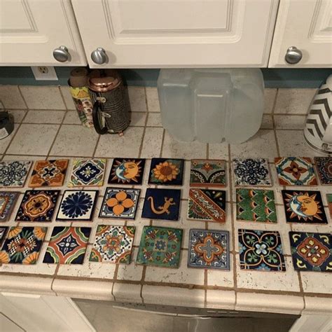 A Tile Backsplash With Colorful Tiles On It