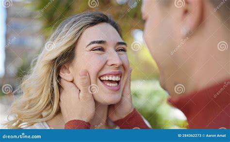 Man And Woman Couple Smiling Confident Hugging Each Other At Park Stock