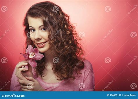 Beautiful Happy Woman With Orchid Flower Over Pink Background Stock