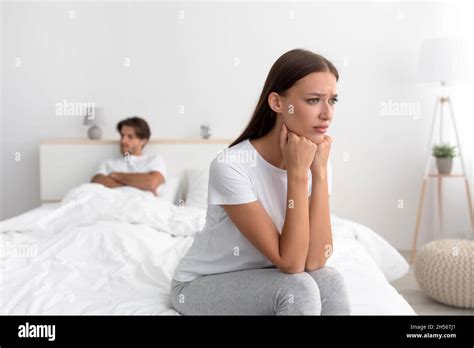 Upset Unhappy Offended Angry Millennial European Wife Sitting On Bed