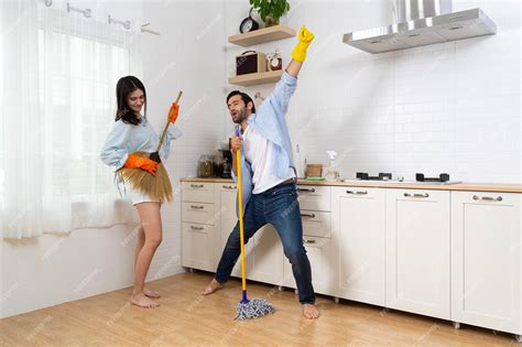 Premium Photo Joyful Loving Couple Singing Songs While Cleaning