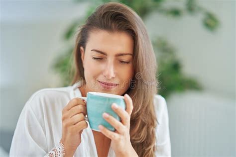 Brunette Woman On Bad In Pajama With Mug With Coffee Or Tea Stock Image