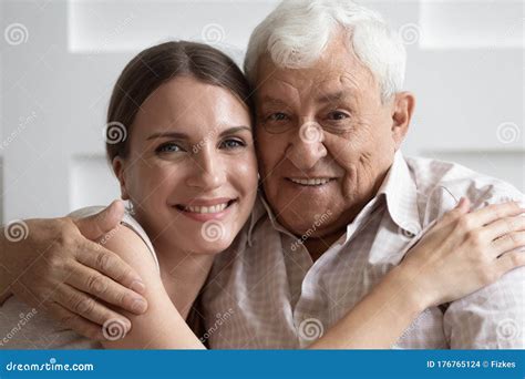 Head Shot Portrait Smiling Older Father And Adult Daughter Hugging
