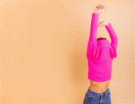 Premium Photo Portrait Of Girl With Her Trendy Sweater Over Her Head