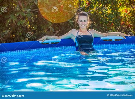 Happy Healthy Woman In Blue Swimwear In Swimming Pool Relaxing Stock