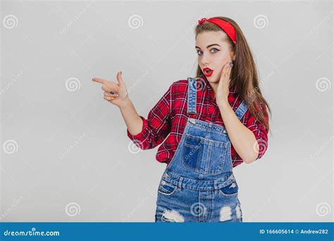 Surprised Pretty Girl With Widely Opened Mouth Hand On The Cheek
