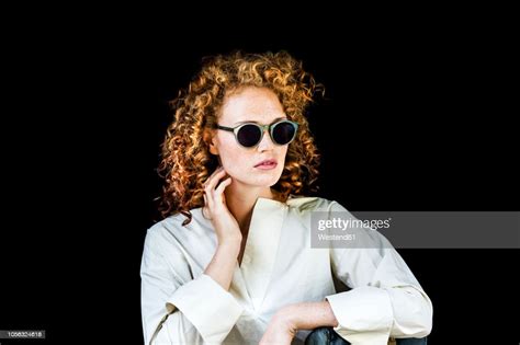Portrait Of Stylish Young Woman With Curly Red Hair Wearing Sunglasses