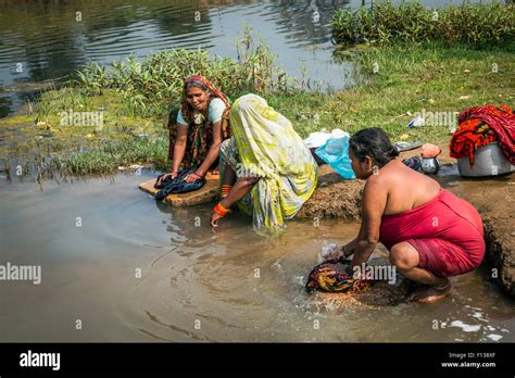 Women Washing Their Clothes On The Banks Of The Mandakini River In
