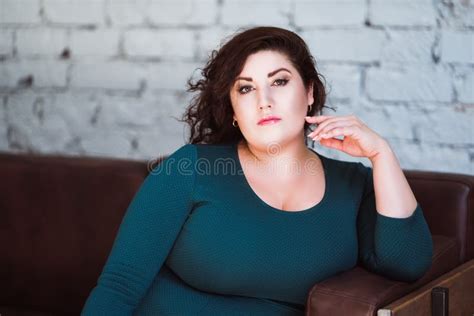 Plus Size Fashion Model In Blue Dress With A Deep Neckline Outdoors