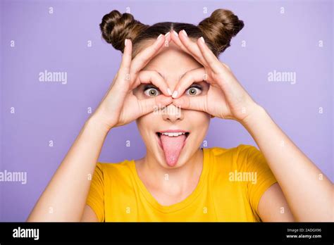 Close Up Photo Of Funky Youngster Lady Holding Hands Near Eyes Making