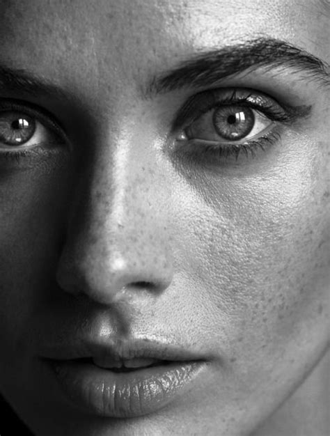 A Woman With Freckled Hair And Blue Eyes Looks At The Camera While