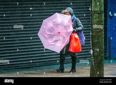 Woman With Pink Inverted Umbrella Outside Shuttered Shop In Preston