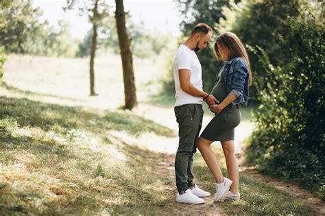 Marido Com Sua Esposa Grávida Andando No Parque Foto Grátis