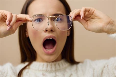 Premium Photo Portrait Of Smiling Girl Holding Eyeglasses