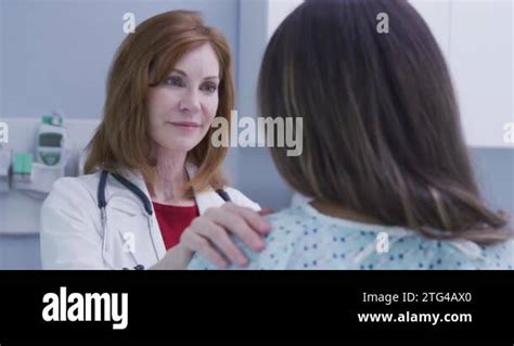 Happy Doctor Telling Patient To Be Positive After Having Accident