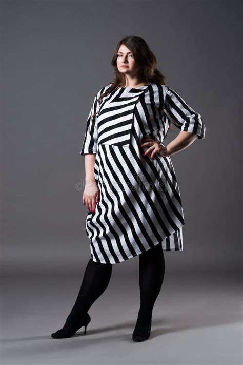 Plus Size Fashion Model In Striped Dress Fat Woman On Gray Background