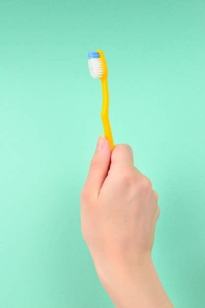Premium Photo The Woman Holds Toothbrushes In Her Hand