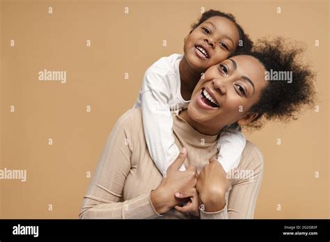 Happy Black Mother And Daughter Hugging While Making Fun Together