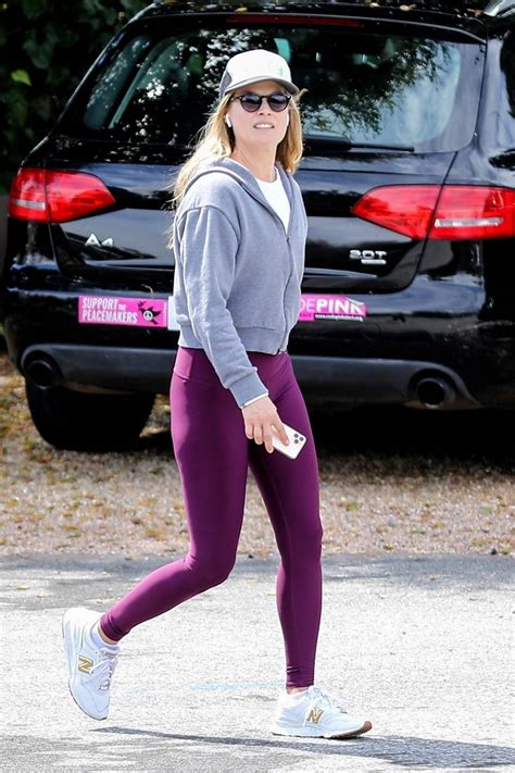 Ali Larter Wears A Grey Jacket And Purple Leggings With A Wrist Brace
