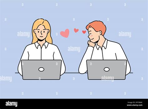 Young Man In Love Look At Female Colleague Working Together At Laptops