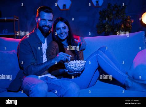 Photo Of Romantic Bonding Couple Sit Cozy Couch Eat Pop Corn Watch