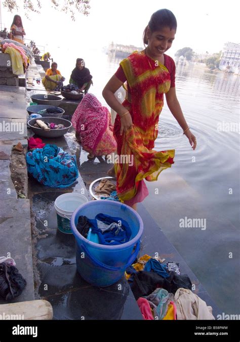 Local Young Beautiful Women Washing Laundry And Chatting Life Style In