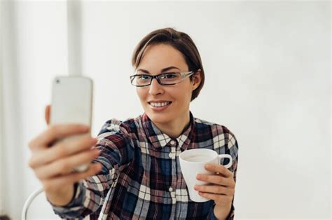 Premium Photo A Beautiful Girl With Glasses Taking Selfie
