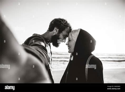 Traveling Couple In Love Taking Selfie On The Deserted Beach At Sunset