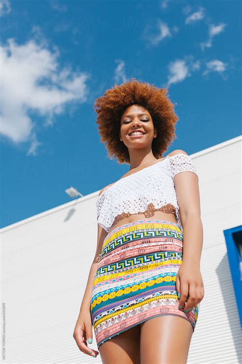 Latin American Afro Woman In A Radiant Summer Day By Stocksy