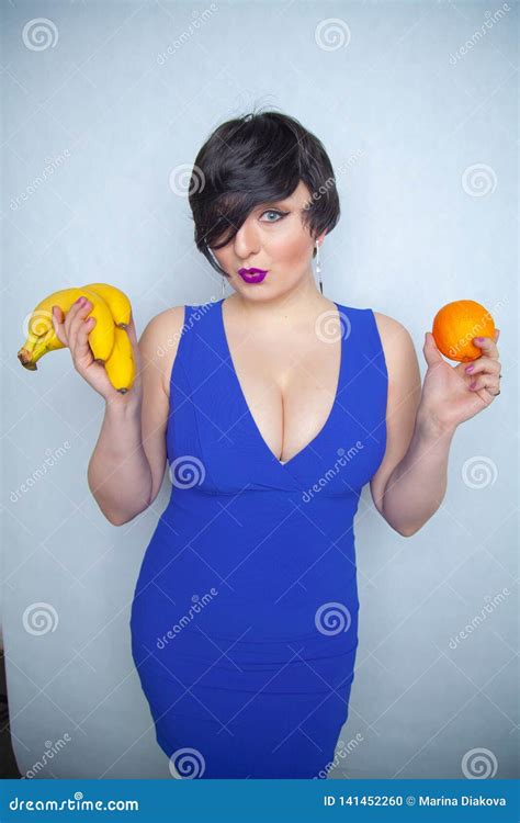 Cute Chubby Girl With Short Black Hair In A Blue Dress Holding An