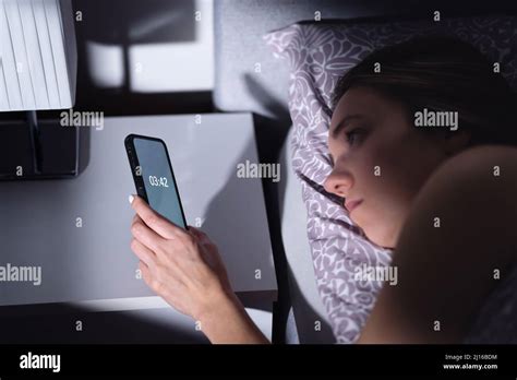 Insomnia Sleepless Woman Looking The Time Unable To Sleep At Night