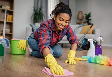 Premium Photo Happy Young Black Lady In Rubber Gloves Washes Floor