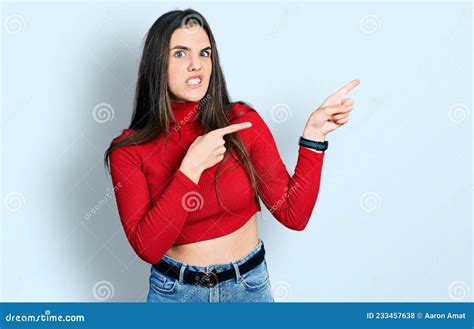Young Brunette Teenager Wearing Red Turtleneck Sweater Pointing Aside