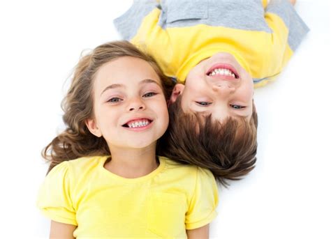 Premium Photo Smiling Siblings Lying On The Floor