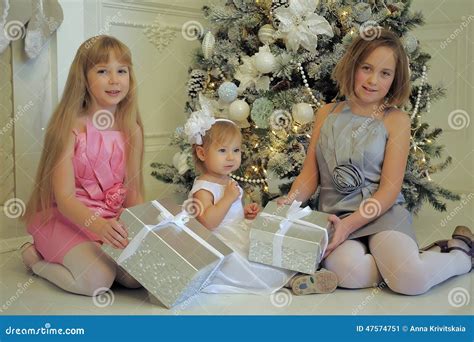 Three Girls Sisters Sitting At The Christmas Tree Stock Image Image