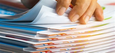 businessman hands searching unfinished documents stacks of paper files