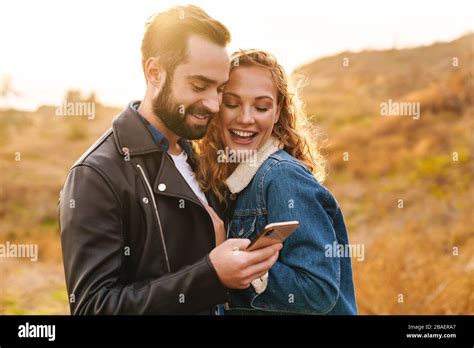 Beautiful Young Happy Stylish Couple Wearing Jackets Standing At The