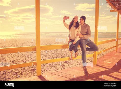 Very Happy Couple In Love Taking Selfie On The Beach In Autmun Day