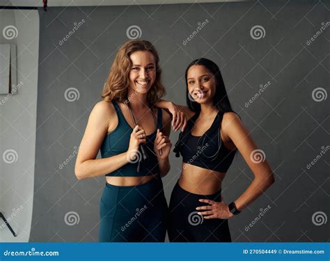 Young Women In Sports Clothing Holding Jump Ropes While Looking At