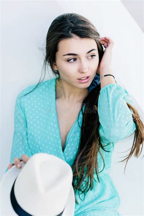 Portrait Of A Young Brunette Girl With Brown Eyes Wears A Hat Stock
