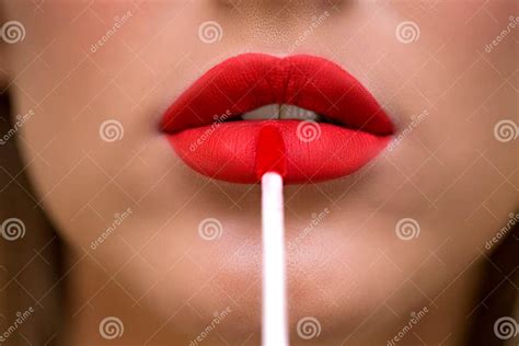 Close Up Portrait Of Attractive Girl Rouging Her Lips She Is Holding