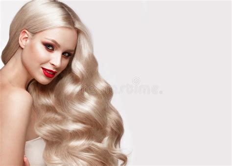 Beautiful Blonde In A Hollywood Manner With Curls Natural Makeup And