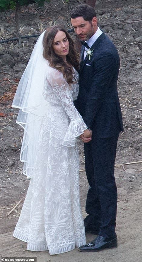 The Bride And Groom Are Standing Together Outside