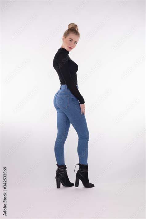 Sexy Teen Girl In Tight Jeans And Sweater Looking Back Over Shoulder