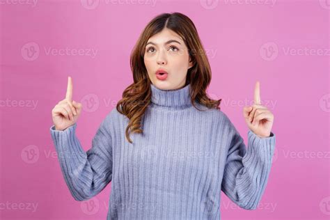 Portrait Of Smiling Cheerful Woman Pointing Finger Up And Having Idea